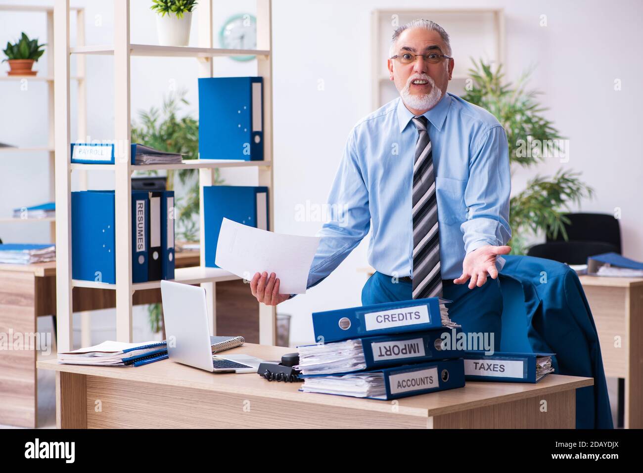 Senior male bookkeeper unhappy with excessive work at workplace Stock ...