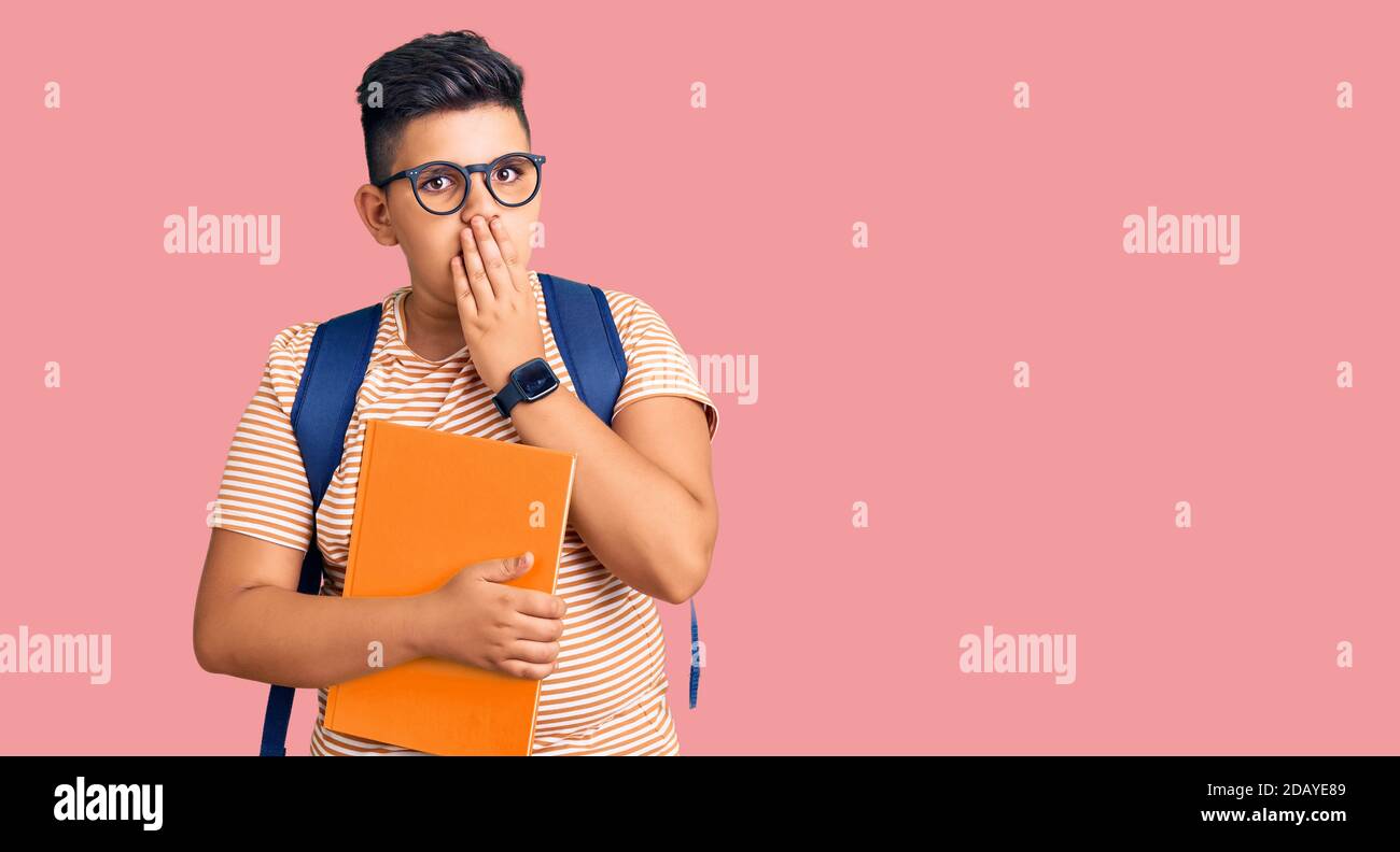 Little boy kid wearing student backpack holding books covering mouth ...