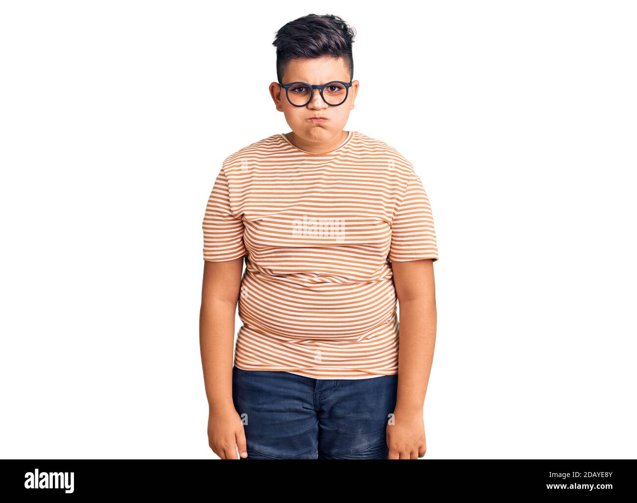 Little boy kid wearing casual clothes and glasses puffing cheeks with ...