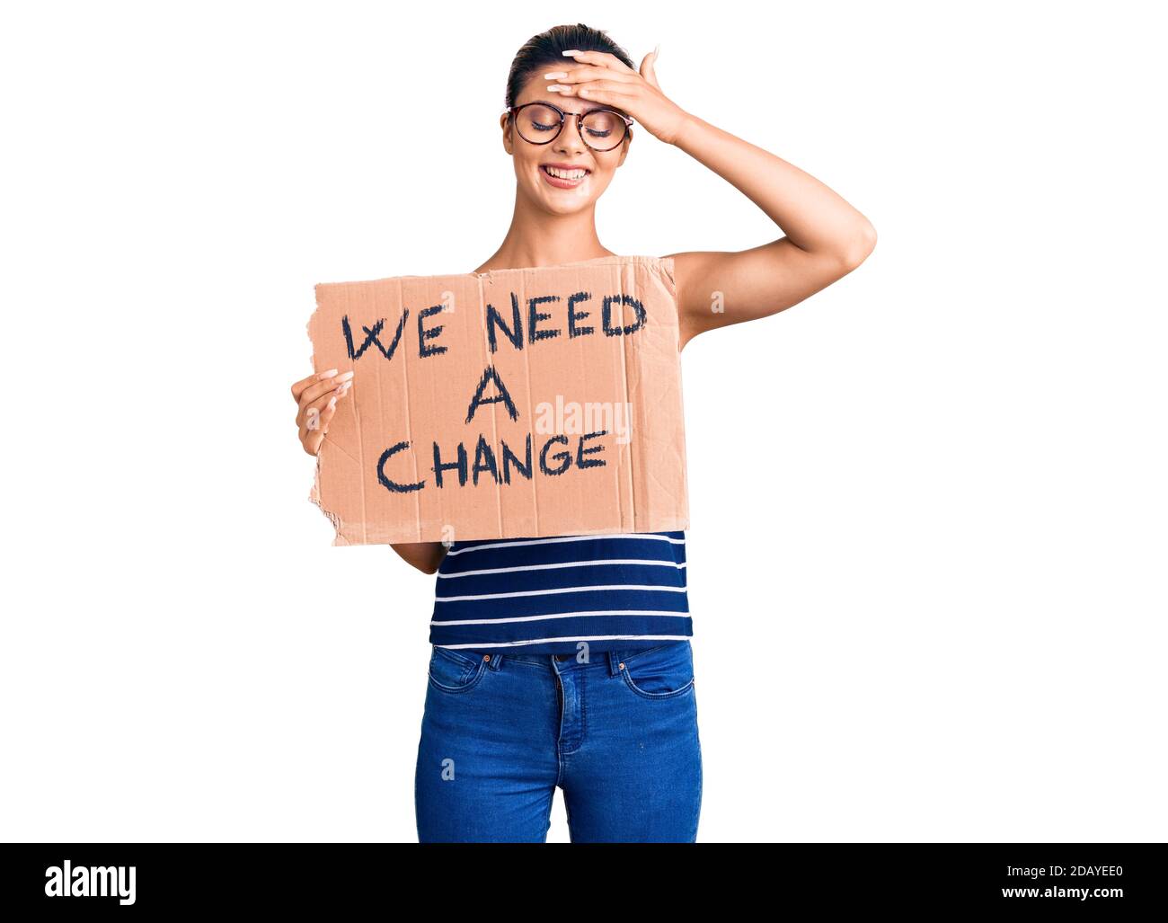 Young beautiful woman holding we need a change banner stressed and ...