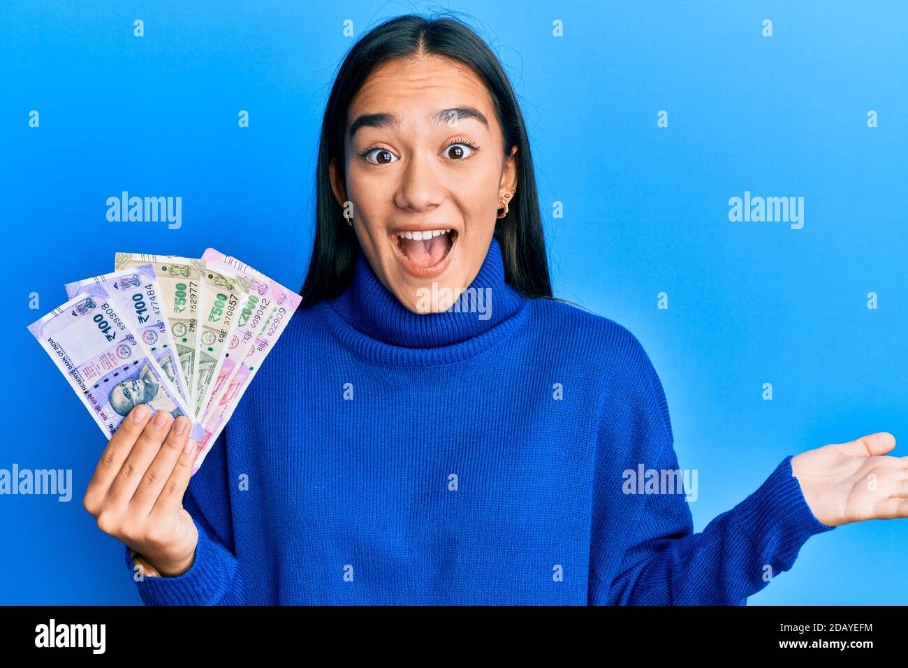Young asian woman holding indian rupee banknotes celebrating ...