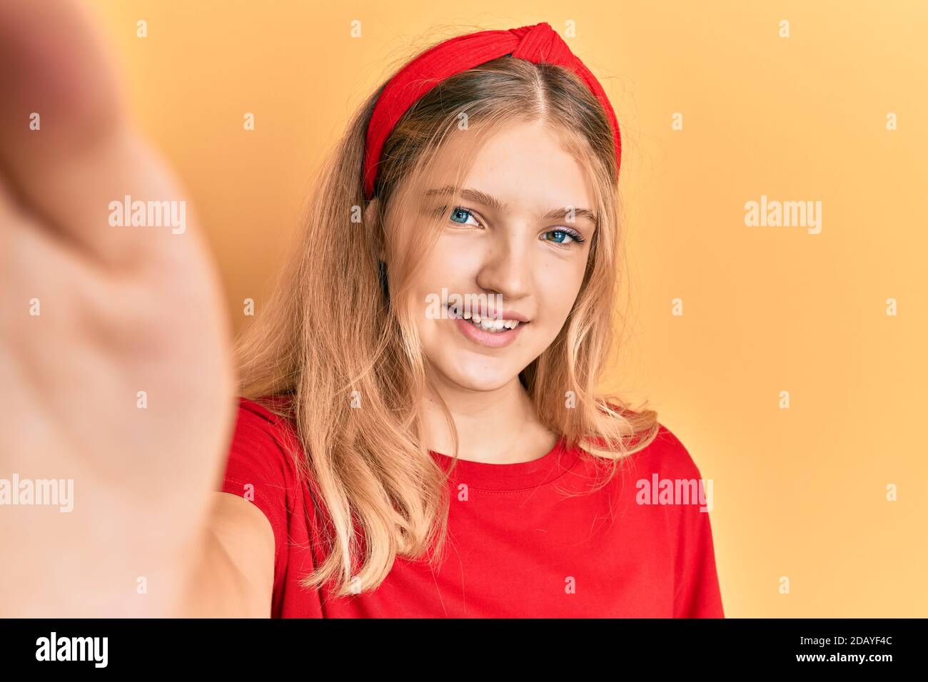 Beautiful young caucasian girl taking a selfie photo looking positive ...
