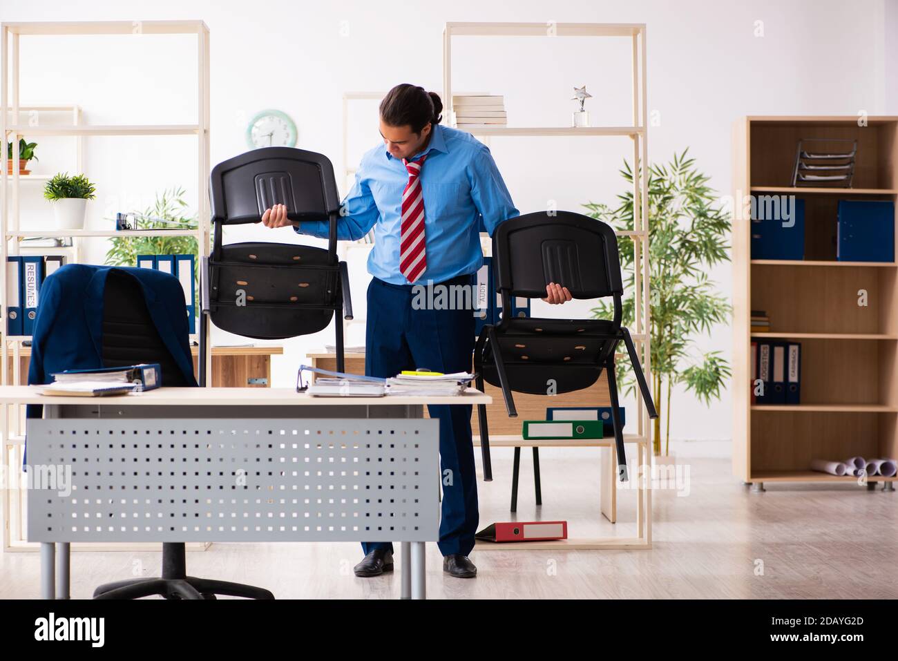 Young businessman doing sport exercises at workplace Stock Photo - Alamy