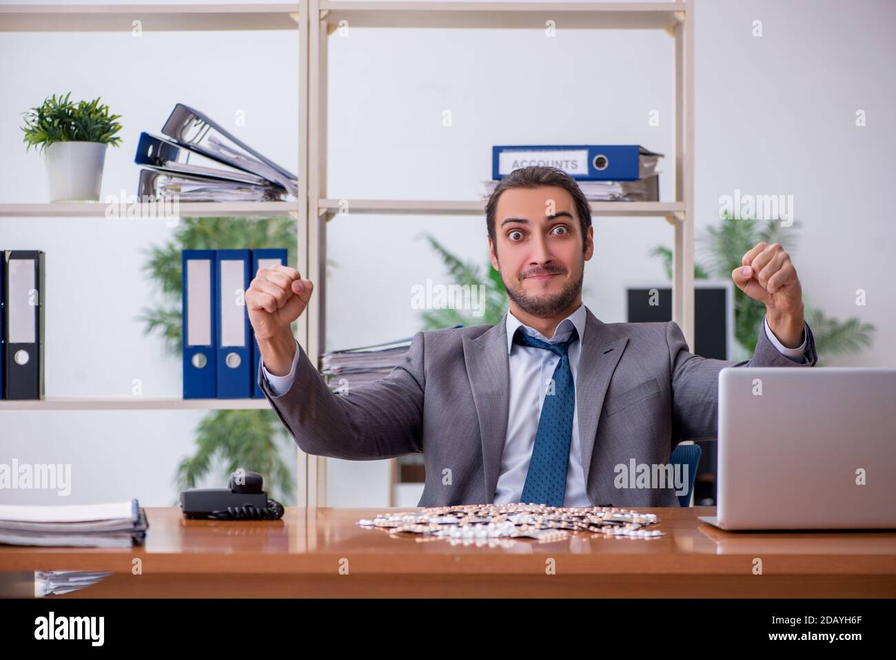 Male sick employee suffering at workplace Stock Photo - Alamy