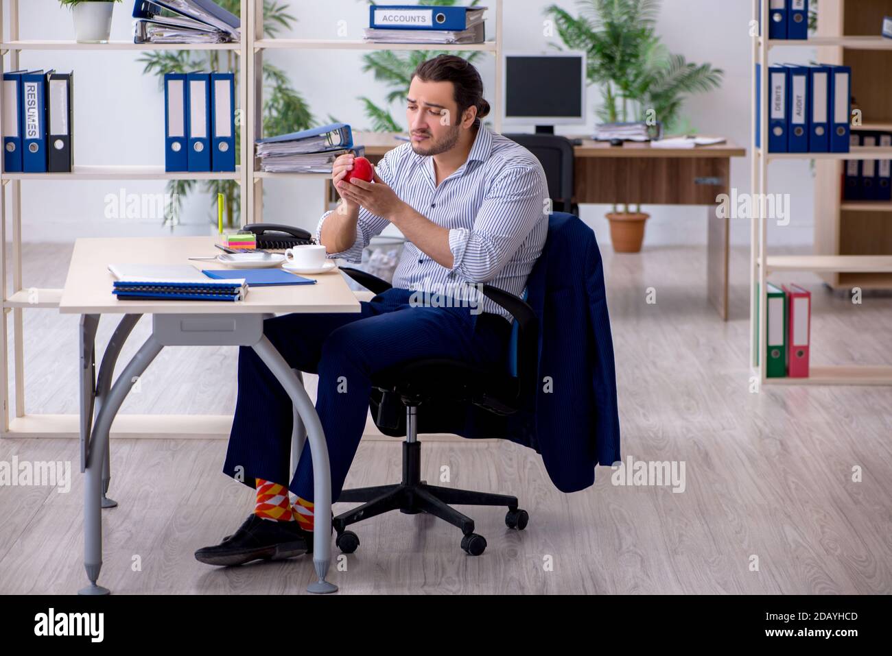 Hungry employee waiting for food at workplace Stock Photo - Alamy