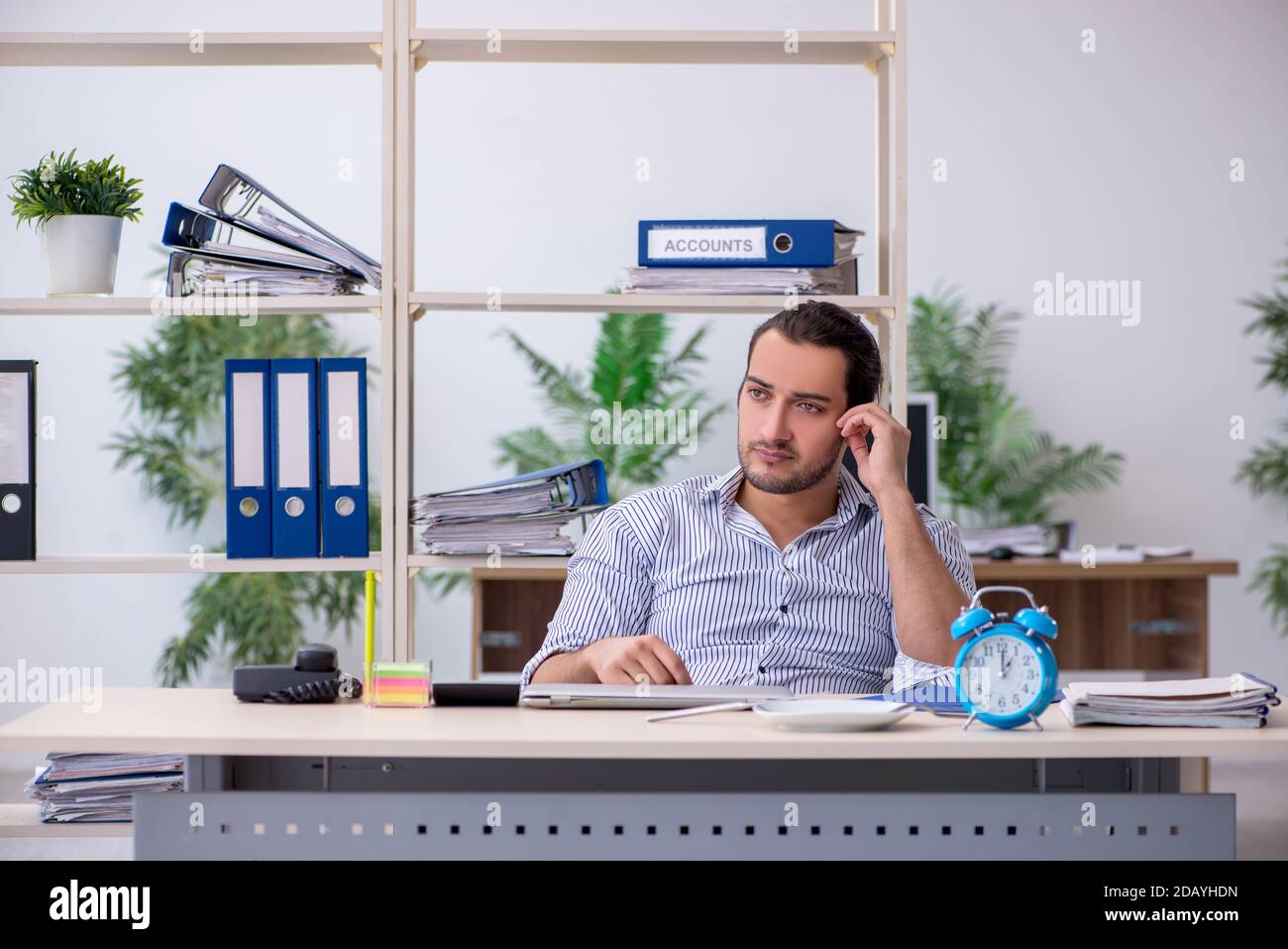 Hungry employee waiting for food in time management concept Stock Photo ...