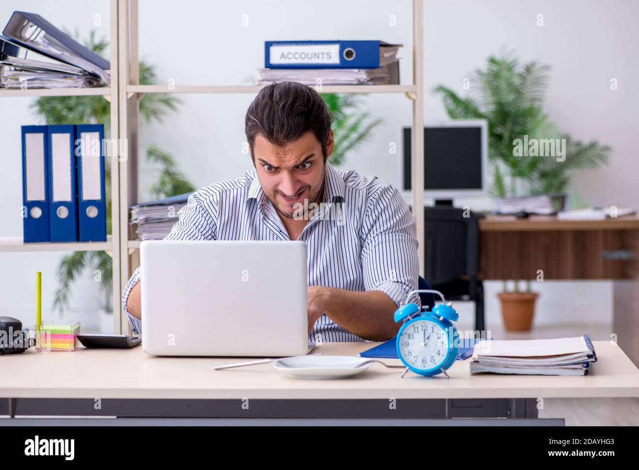 Hungry employee waiting for food in time management concept Stock Photo ...