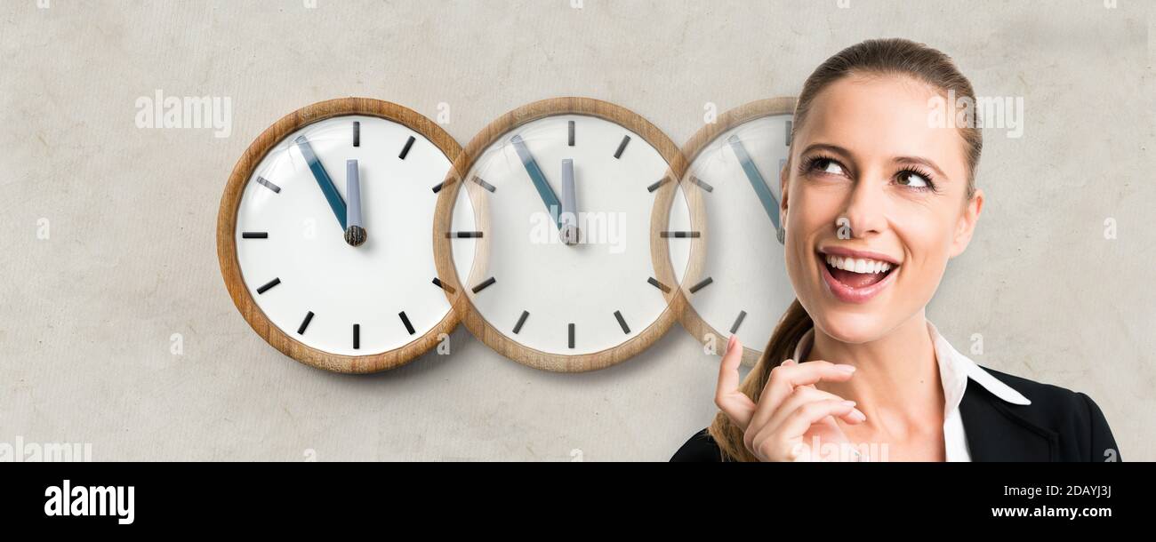 smiling businesswoman in front of background with fading clock faces ...