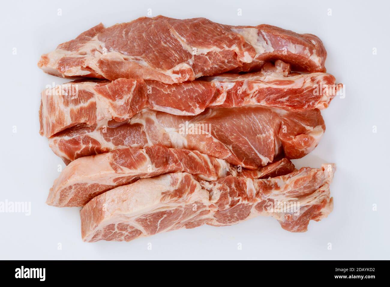 Raw sliced pork meat isolated on white background Stock Photo - Alamy