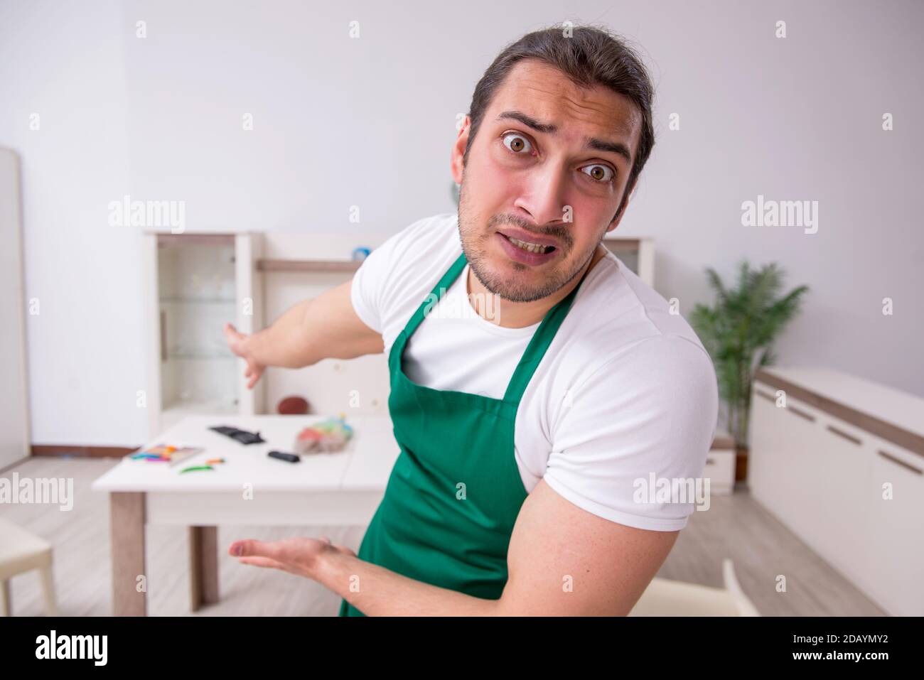 Young contractor cleaning the flat after kids' party Stock Photo - Alamy