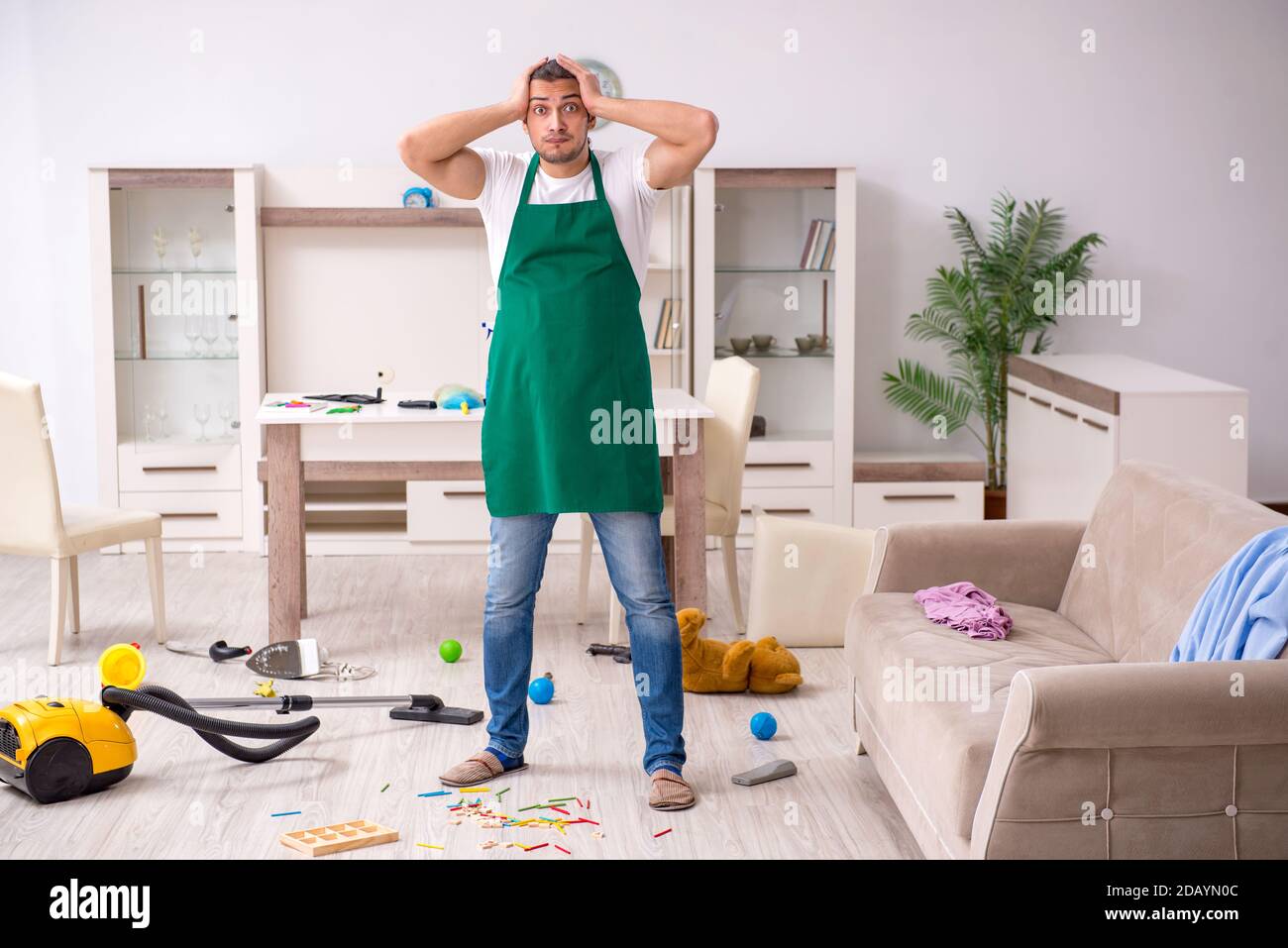 Young contractor cleaning the flat after kids' party Stock Photo - Alamy