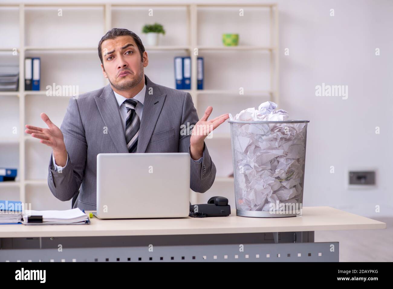 Businessman rejecting new ideas with lots of papers Stock Photo - Alamy