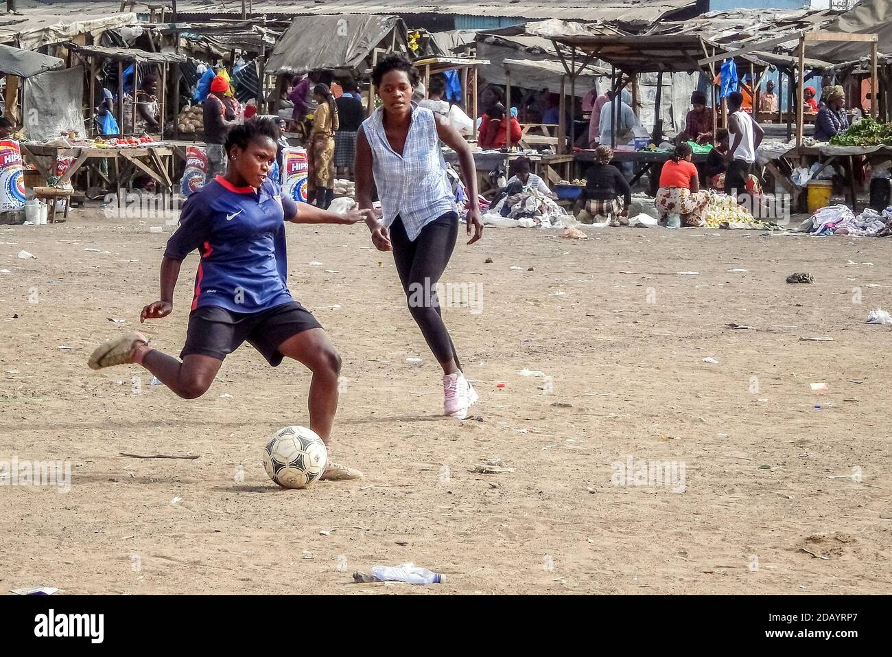 Queen Daka (left) and Janet Musonda practice football on a makeshift ...