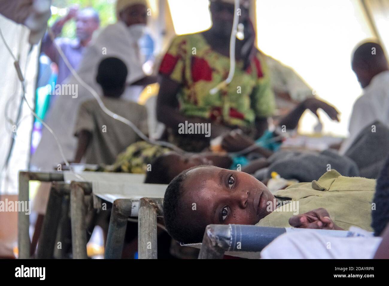 A young boy lies on a hospital bed after being admitted to a cholera ...