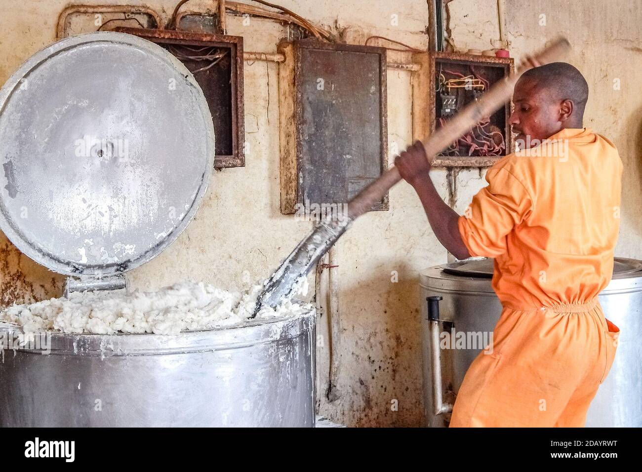 A prisoner prepares nshima, a common Zambian meal, for fellow inmates ...