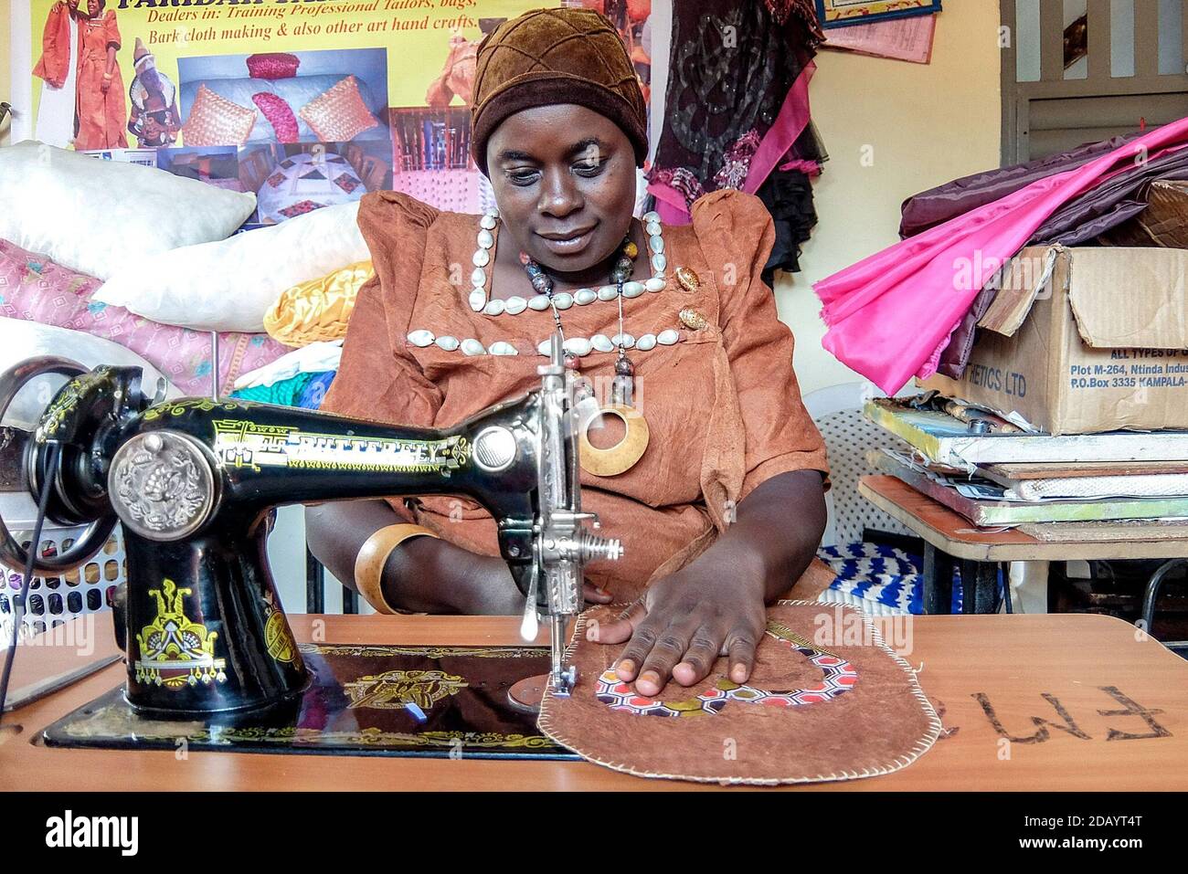 Faridah Kyambadde, a tailor who uses bark cloth to make clothing items ...