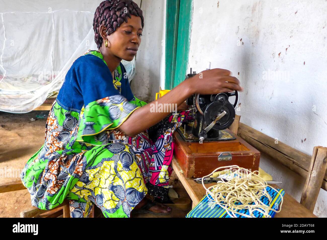 A woman sews clothing in Democratic Republic of Congo Stock Photo - Alamy