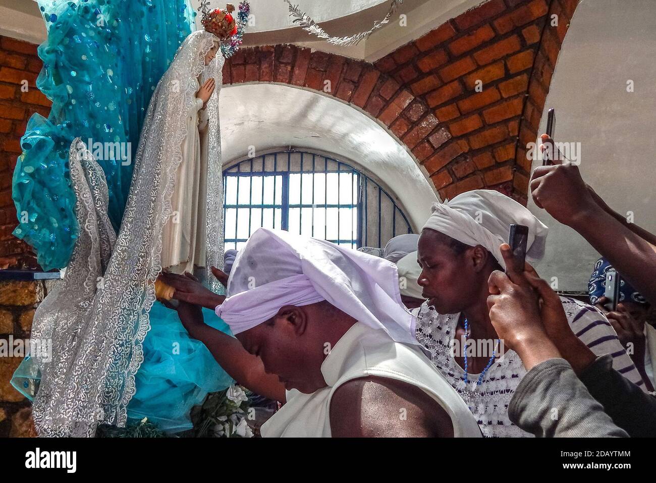 Roman Catholic churchgoers pray before a statue of the Virgin Mary at ...