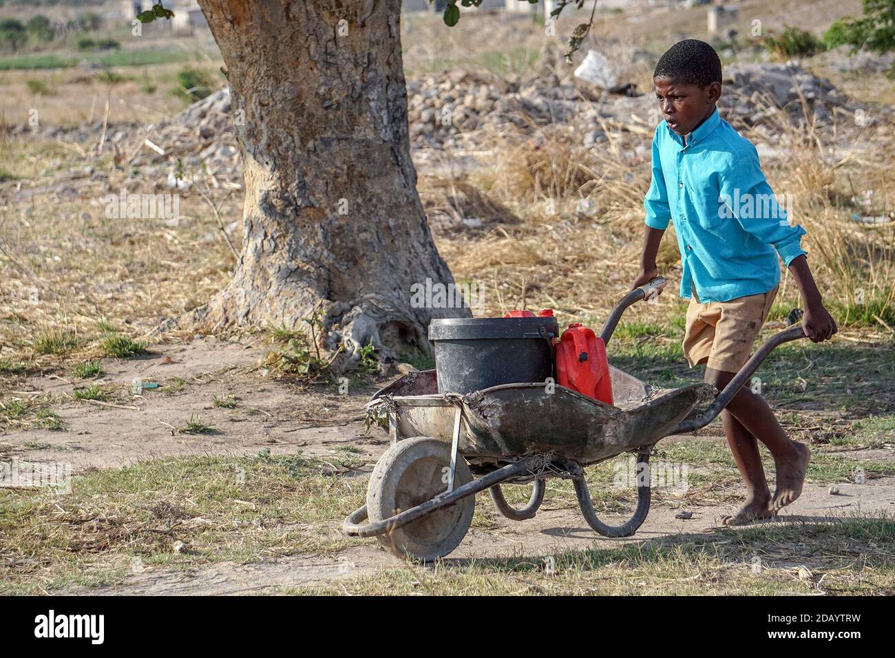 Clemence Mashavira, 10, brings water from a community well in the ...
