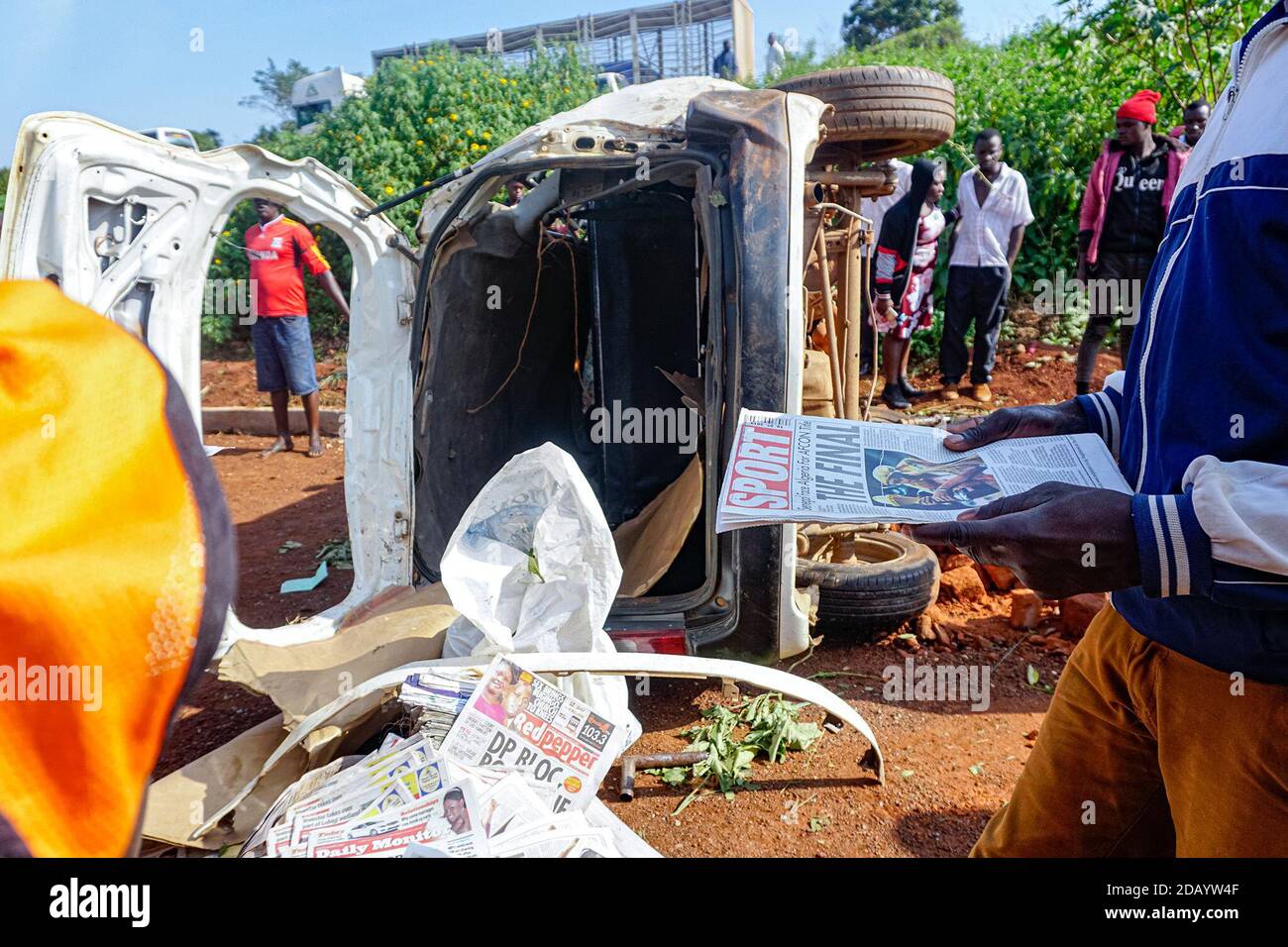 People gather at the site of a car accident off of Iganga-Jinja highway ...