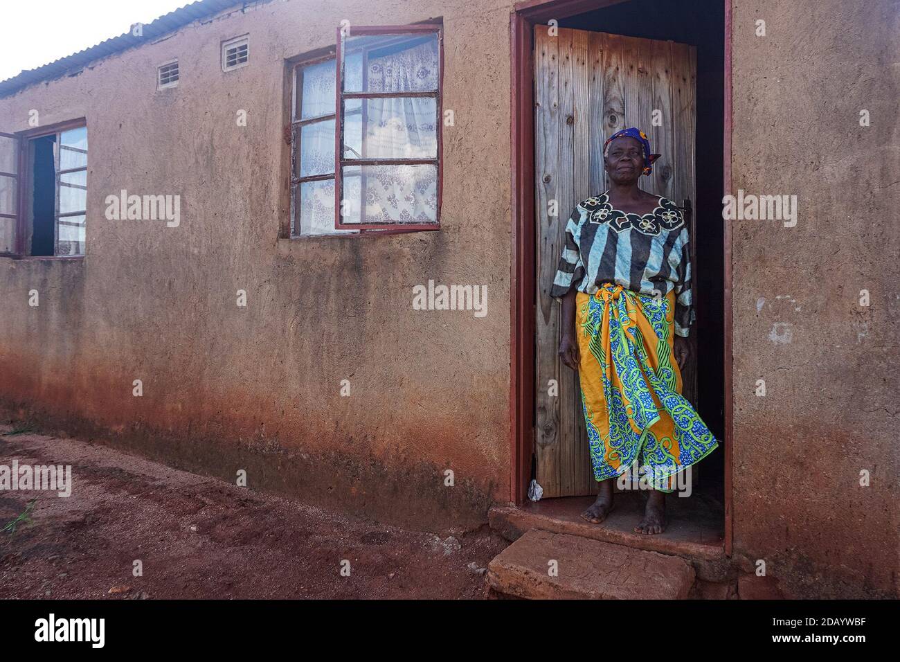 Grace Mapiri stands at the door of her house in Zimbabwe Stock Photo ...