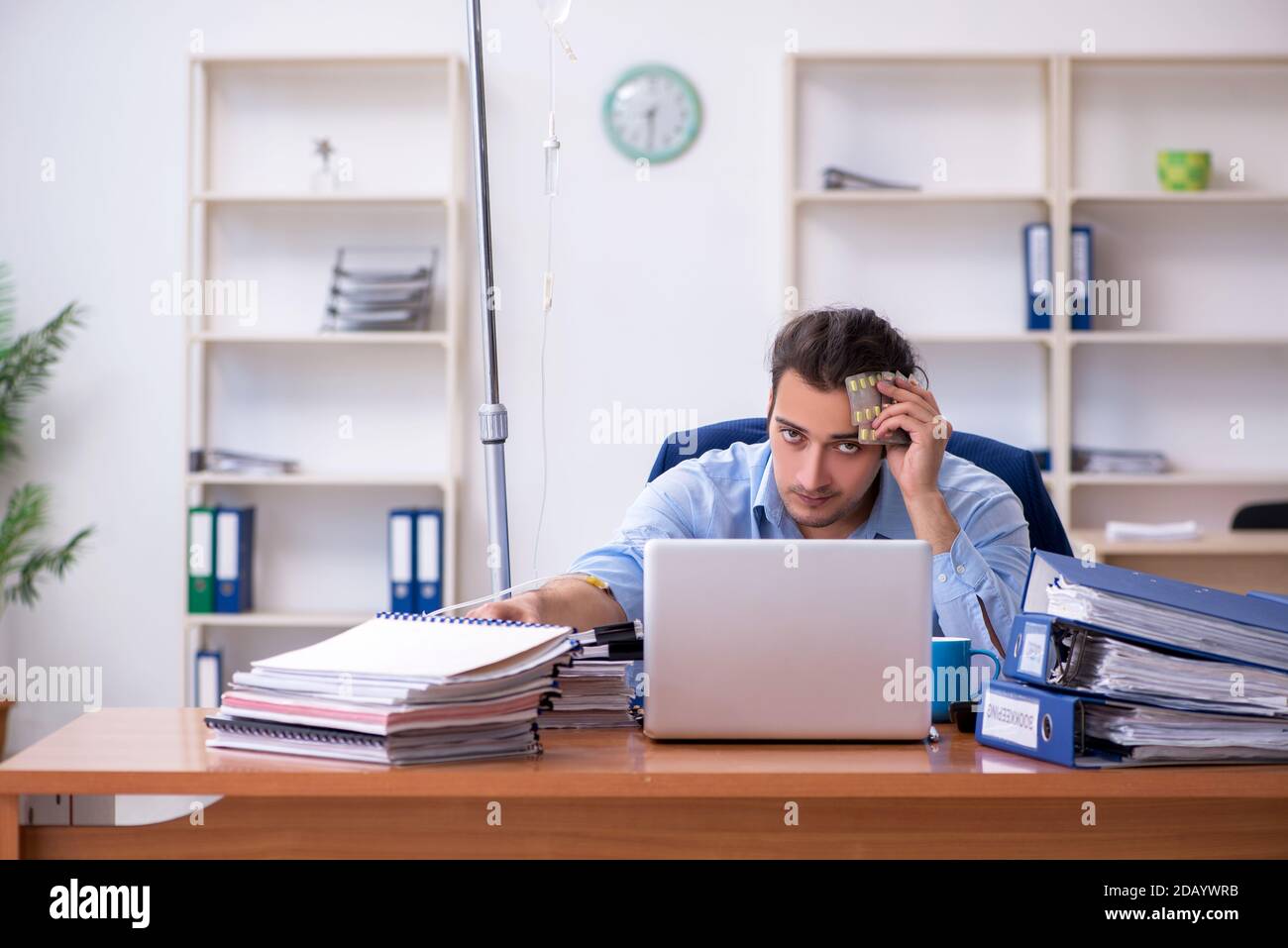 Male employee suffering at workplace Stock Photo - Alamy