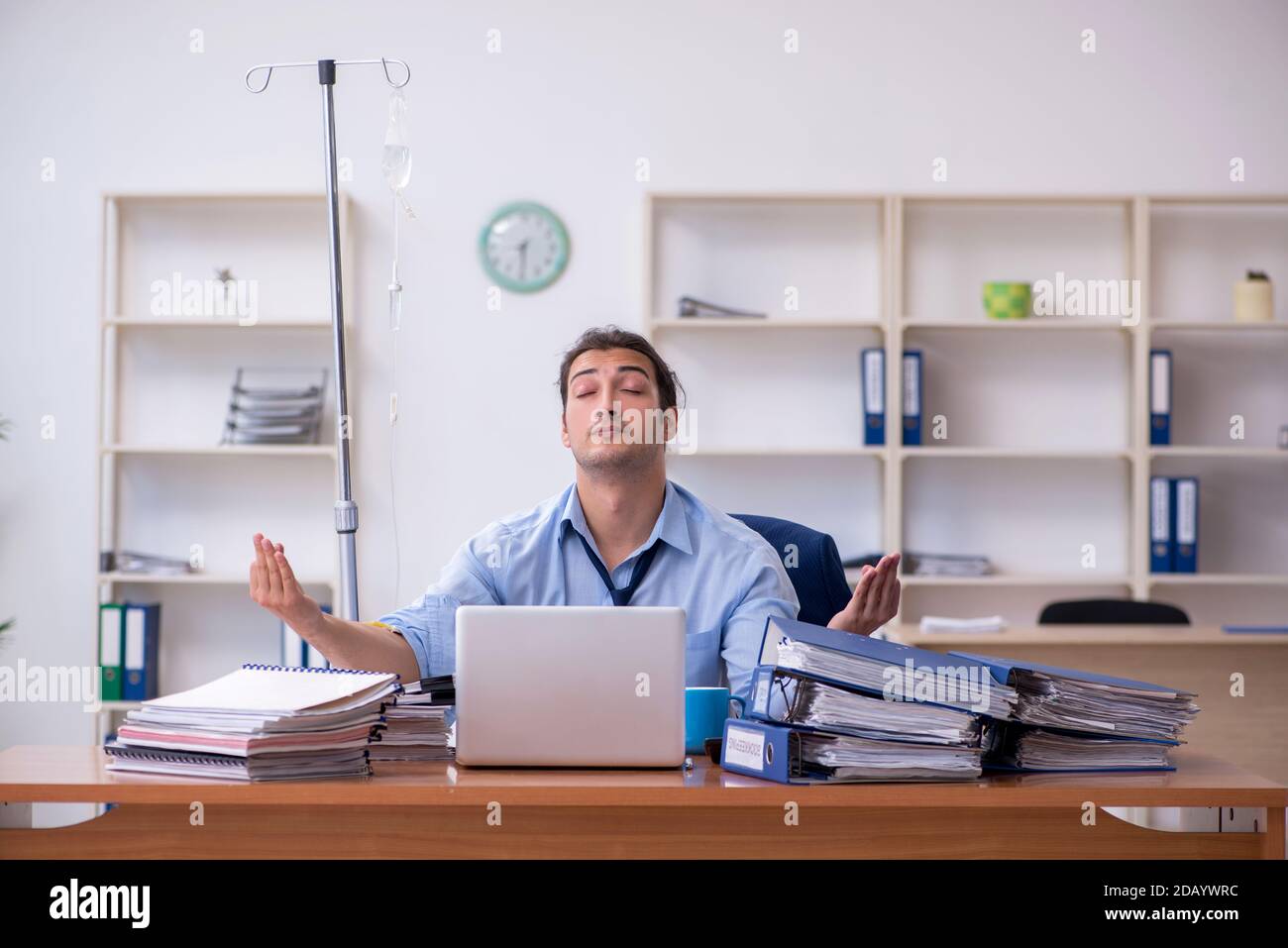 Male employee suffering at workplace Stock Photo - Alamy