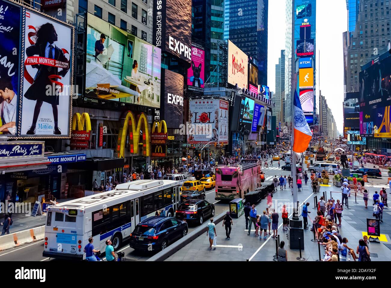 Times Square with yellow New York City Taxi cabs and tour buses driving ...