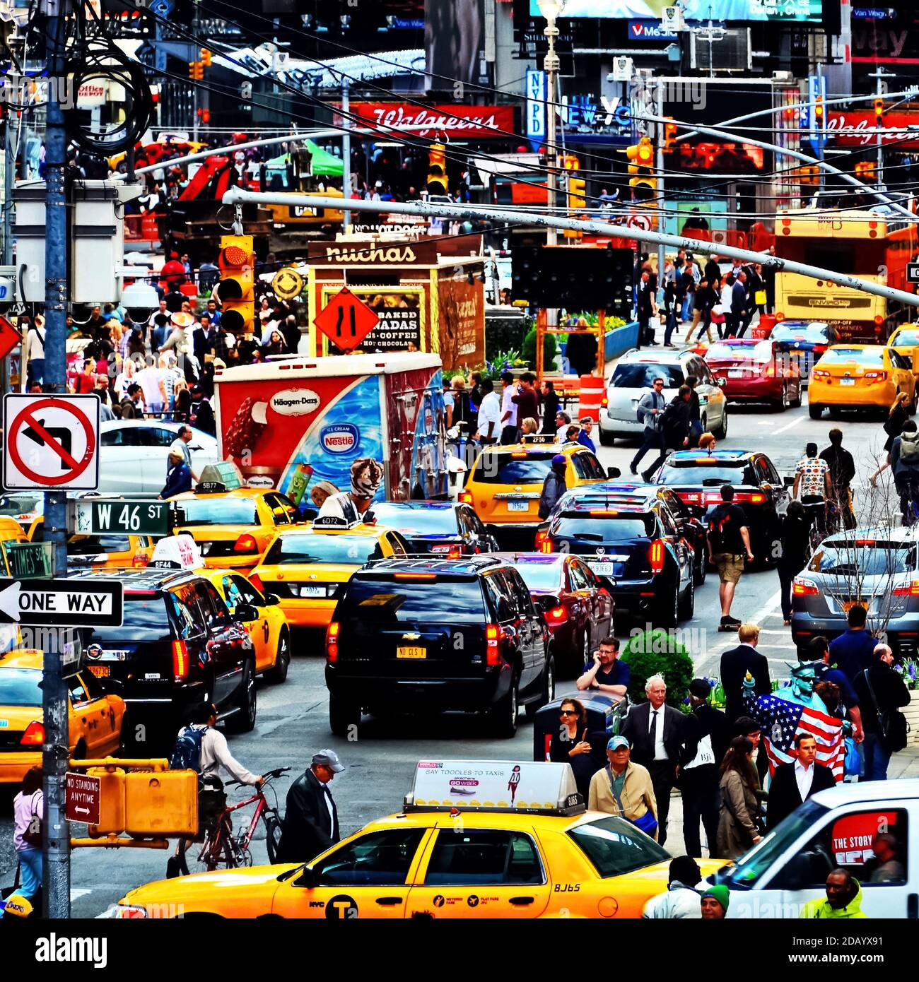 Times Square with yellow New York City Taxi cabs and tour buses driving ...