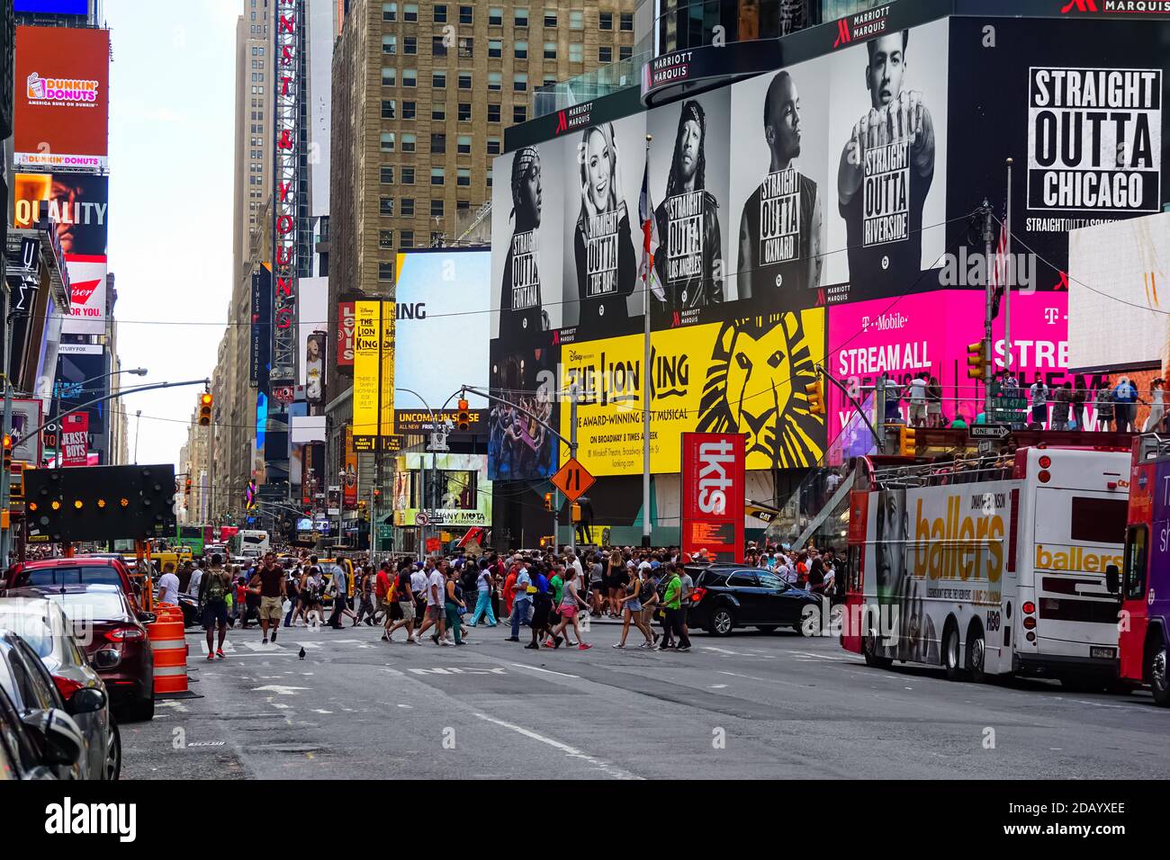 Times Square with yellow New York City Taxi cabs and tour buses driving ...