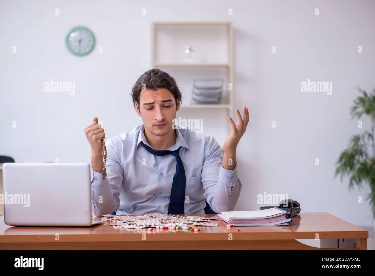 Sick male employee suffering at workplace Stock Photo - Alamy