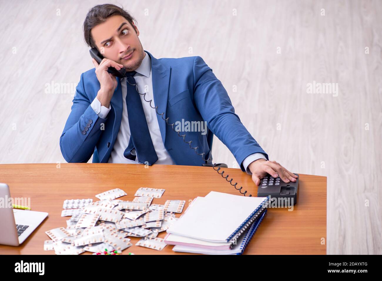 Sick male employee suffering at workplace Stock Photo - Alamy