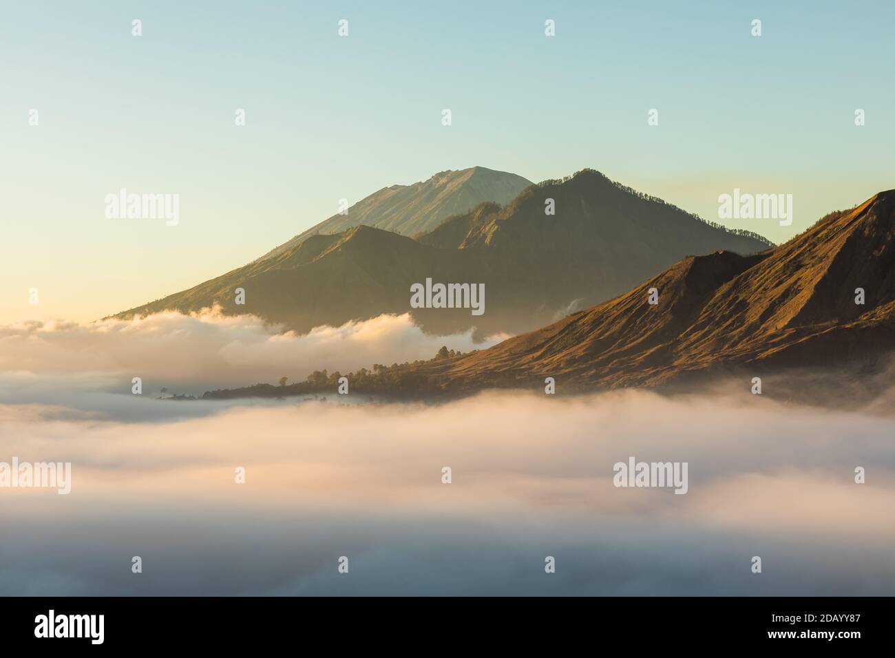 Sunrise view of mount Batur, Abang and Agung volcano in Bali from ...