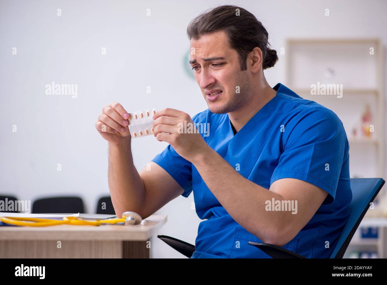 Young sick doctor being unhappy after night shift Stock Photo - Alamy