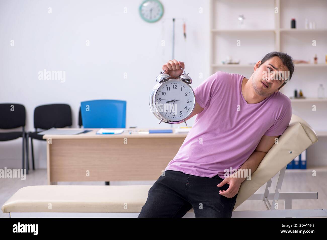 Male patient waiting for doctor in time management concept Stock Photo ...