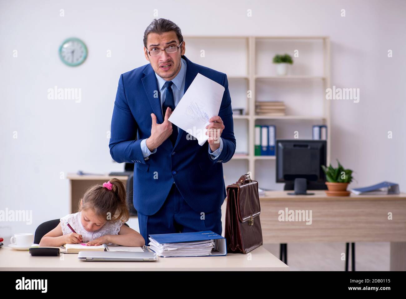Young male employee and his small girl in the office Stock Photo - Alamy