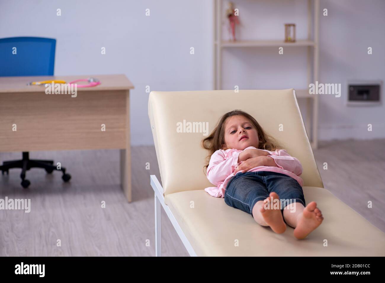 Little girl waiting for doctor in the clinic Stock Photo - Alamy