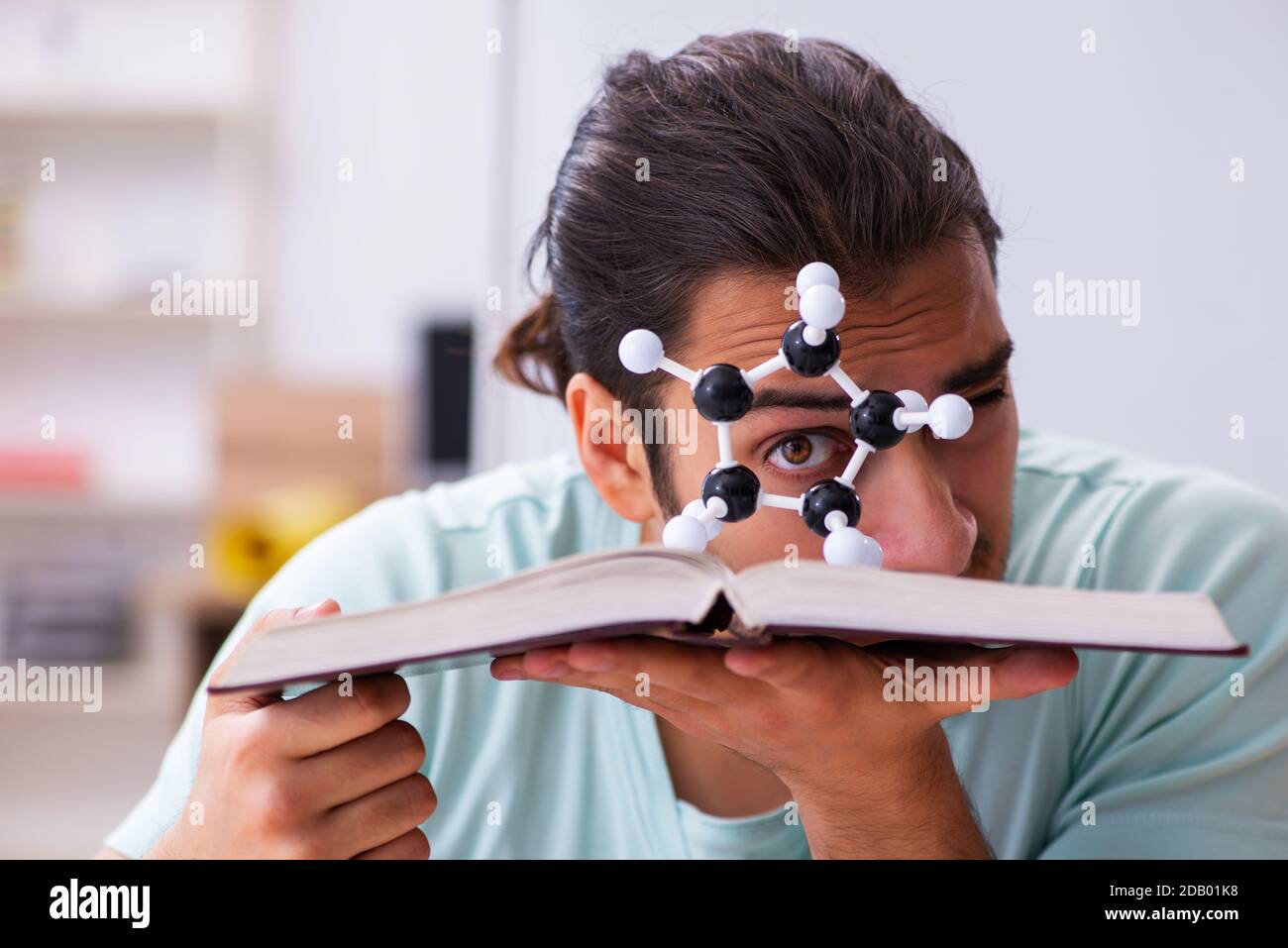 Young student physicist studying molecular model at home Stock Photo ...