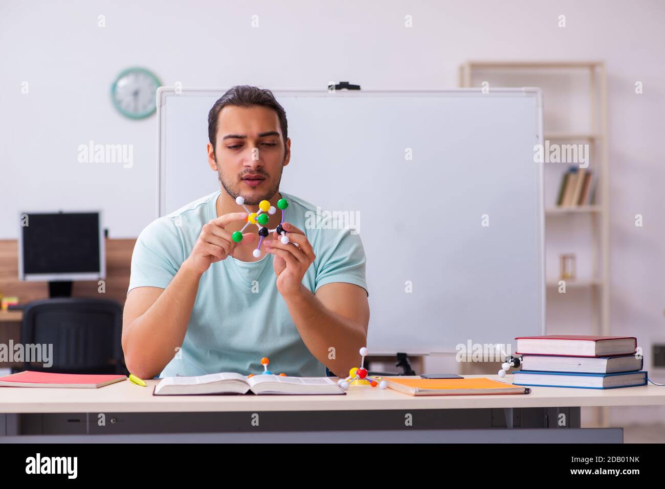 Young student physicist studying molecular model at home Stock Photo ...
