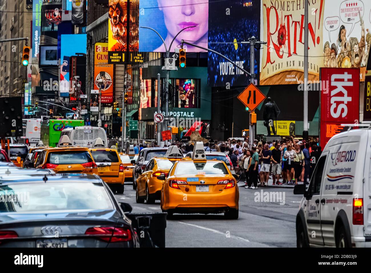 Times Square with yellow New York City Taxi cabs and tour buses driving ...