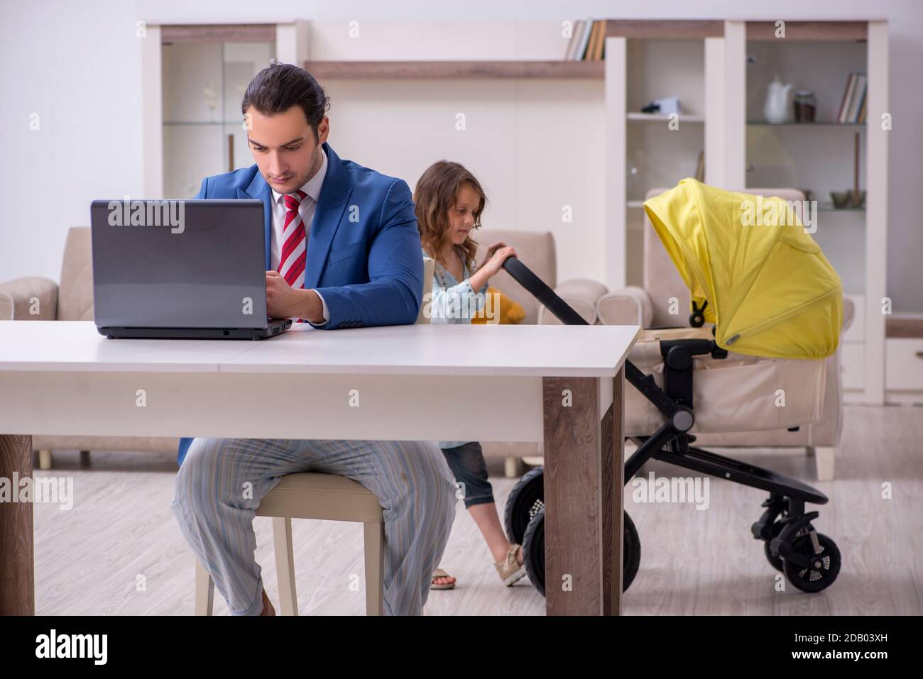 Young father of two children working from house Stock Photo - Alamy