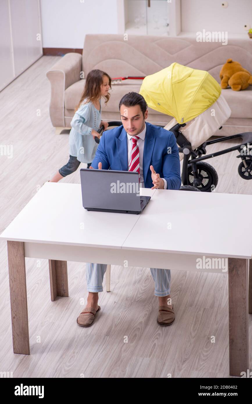 Young father of two children working from house Stock Photo - Alamy