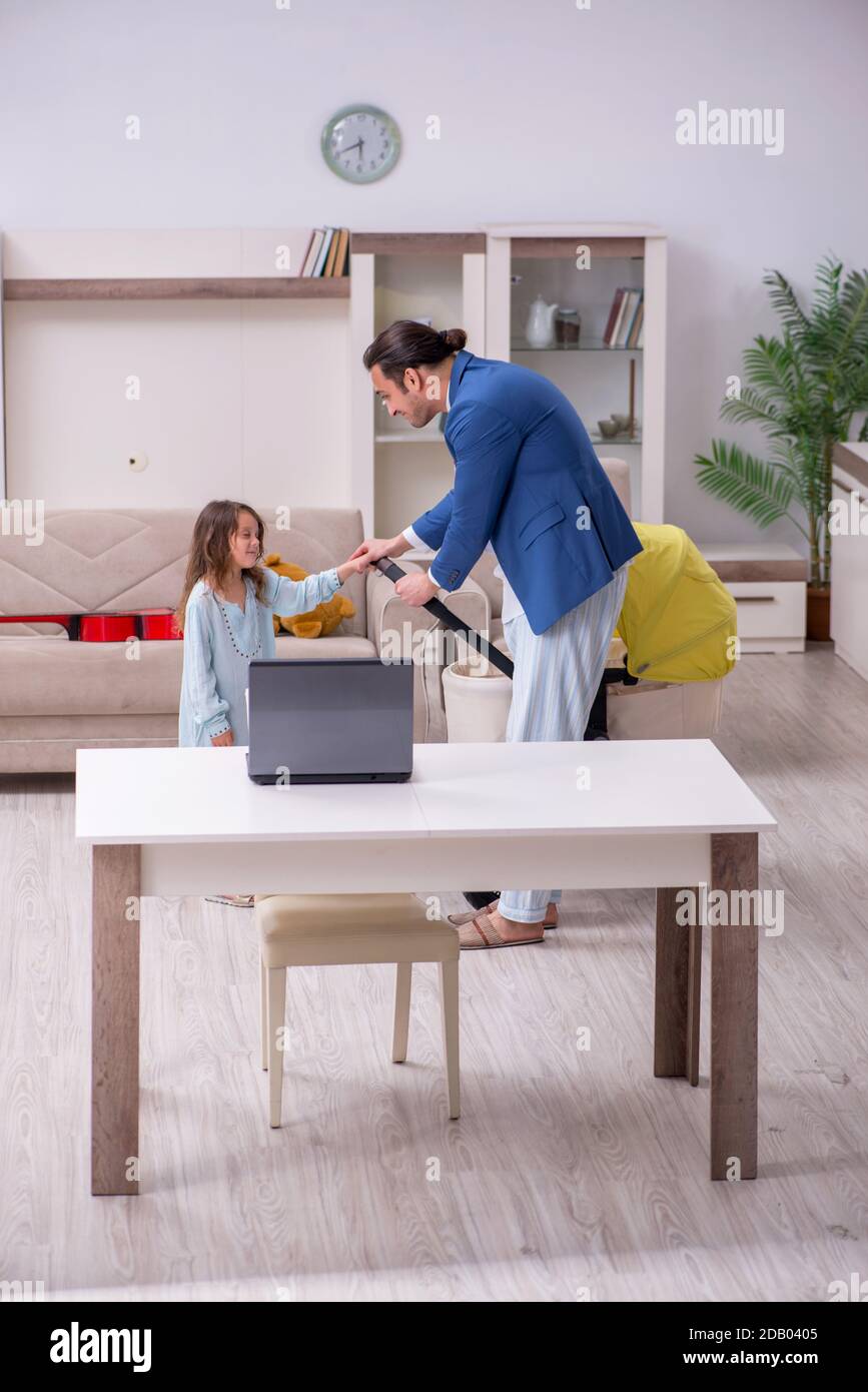 Young father of two children working from house Stock Photo - Alamy