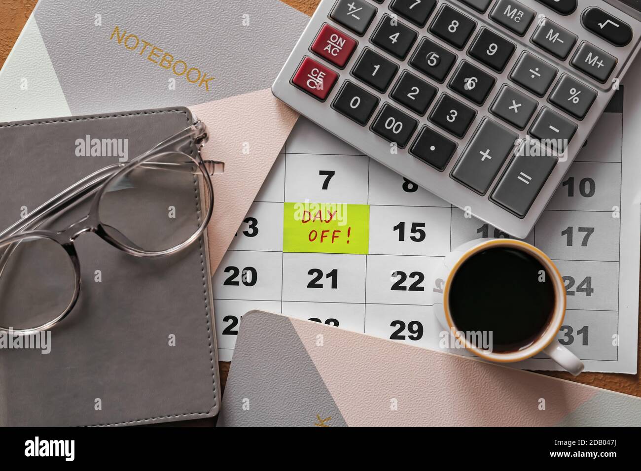 Stationery with cup of coffee and calendar with text DAY OFF at ...