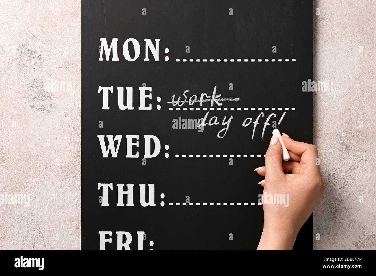 Woman marking day off in to-do list, top view Stock Photo - Alamy