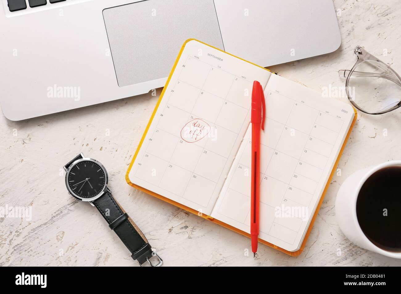 Calendar with marked day off at workplace Stock Photo - Alamy