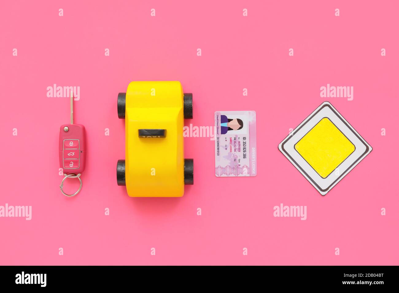 Driving license with car, key and traffic sign on color background ...