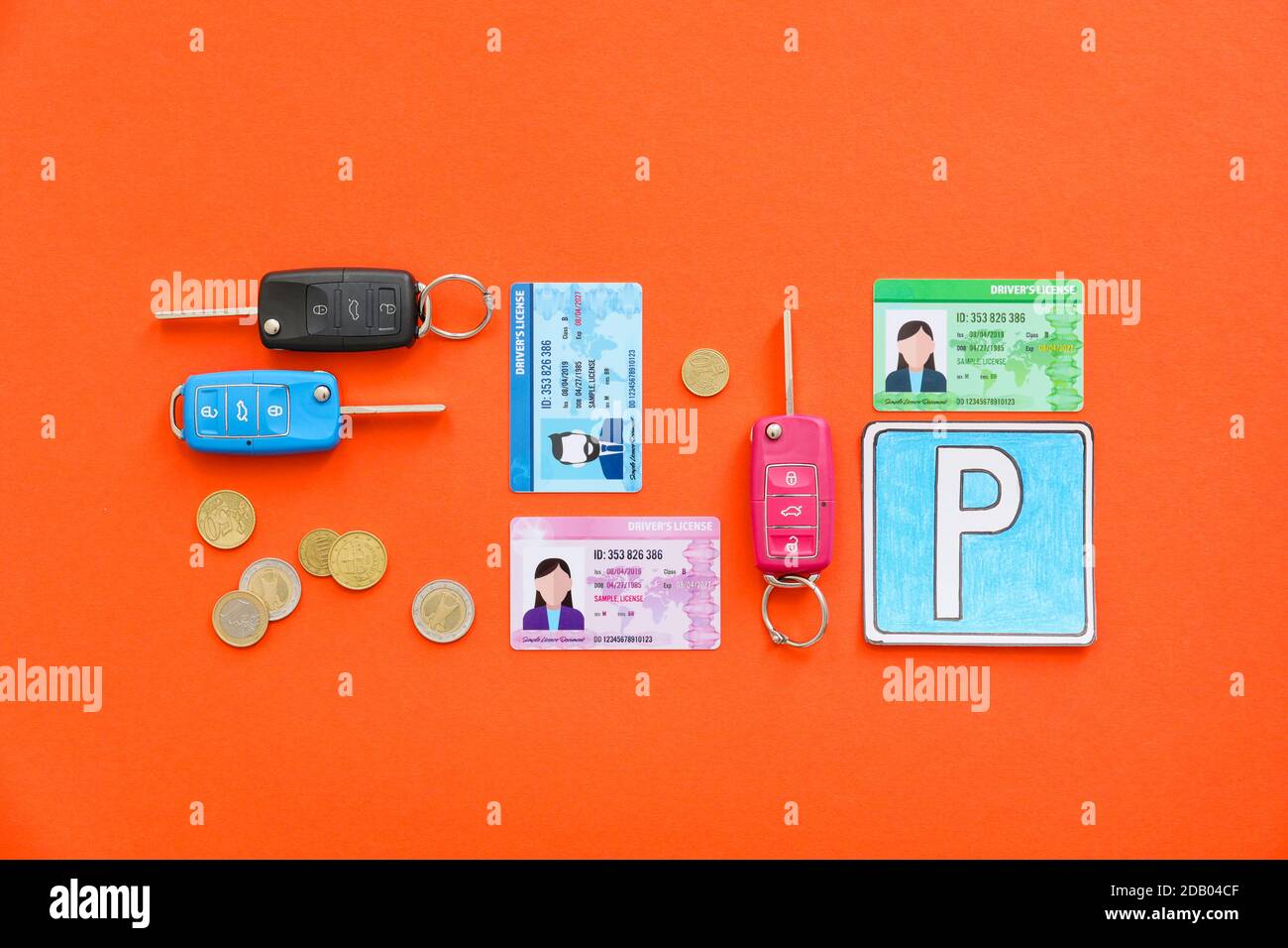 Driving licenses with car keys, coins and traffic sign on color ...
