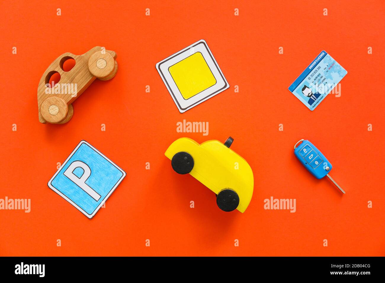 Driving license with cars, key and traffic signs on color background ...
