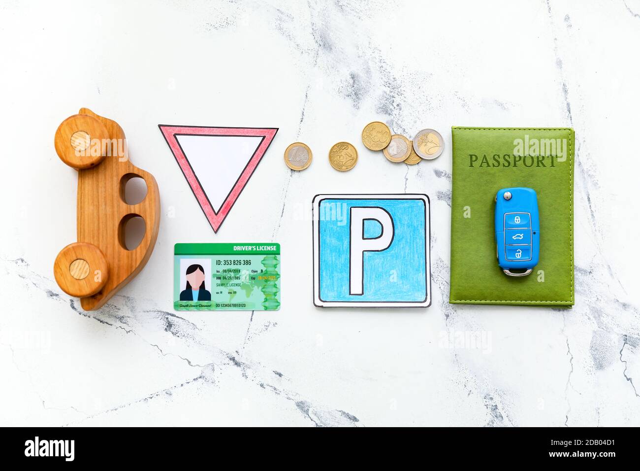 Driving license with car, key, passport and traffic signs on white ...